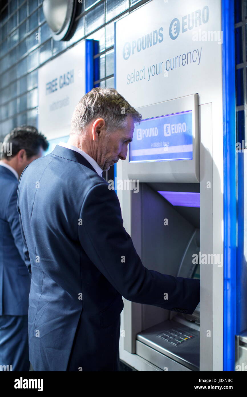 Man using cash machine Stock Photo - Alamy
