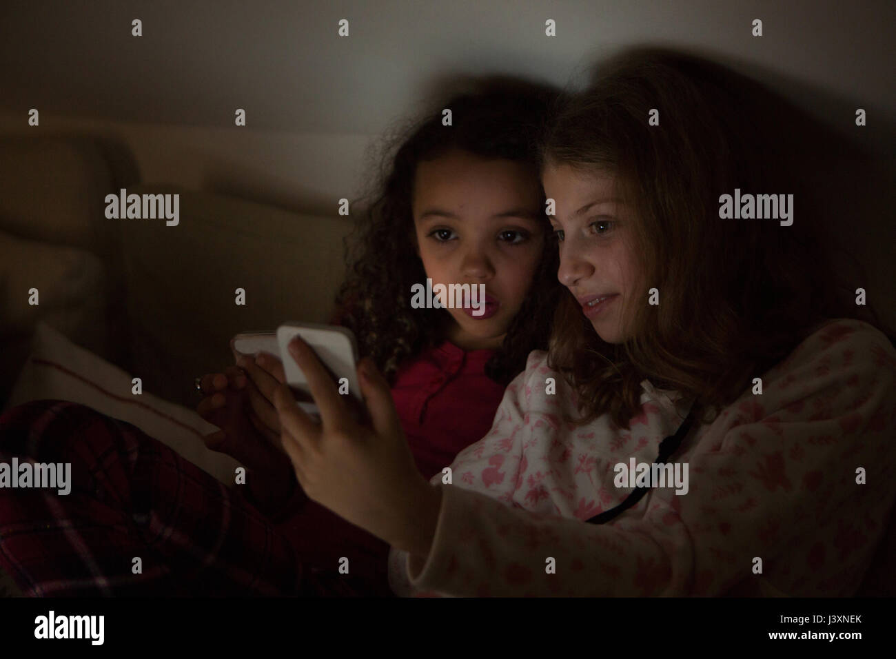 Girls slumber party using smartphones Stock Photo - Alamy