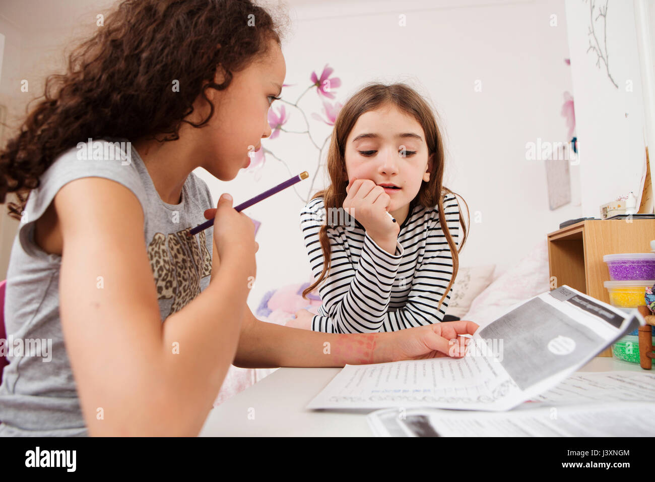 Girls doing homework Stock Photo - Alamy