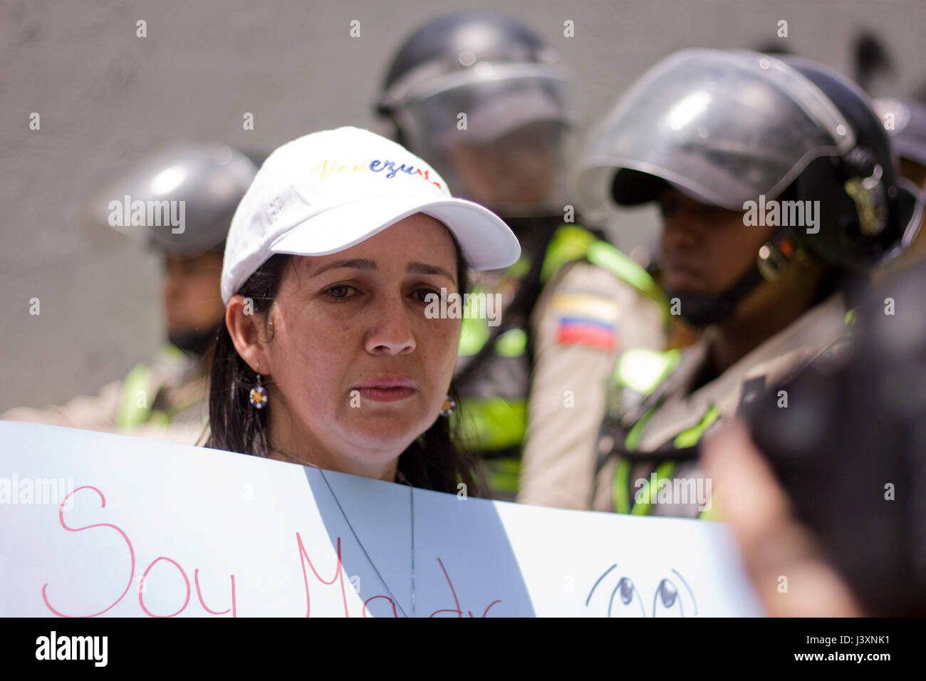 A woman cries in front of a group of females police officers during a ...