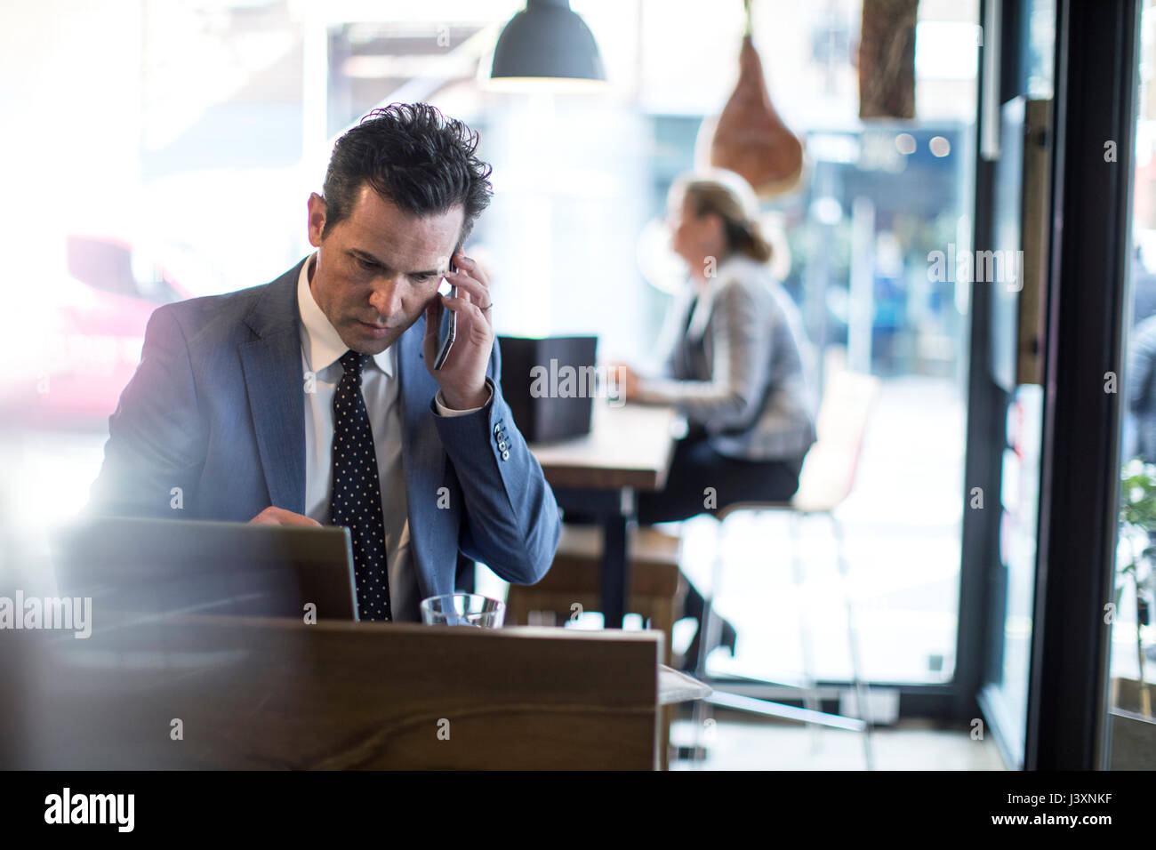 Mature businessman making smartphone call in restaurant Stock Photo - Alamy