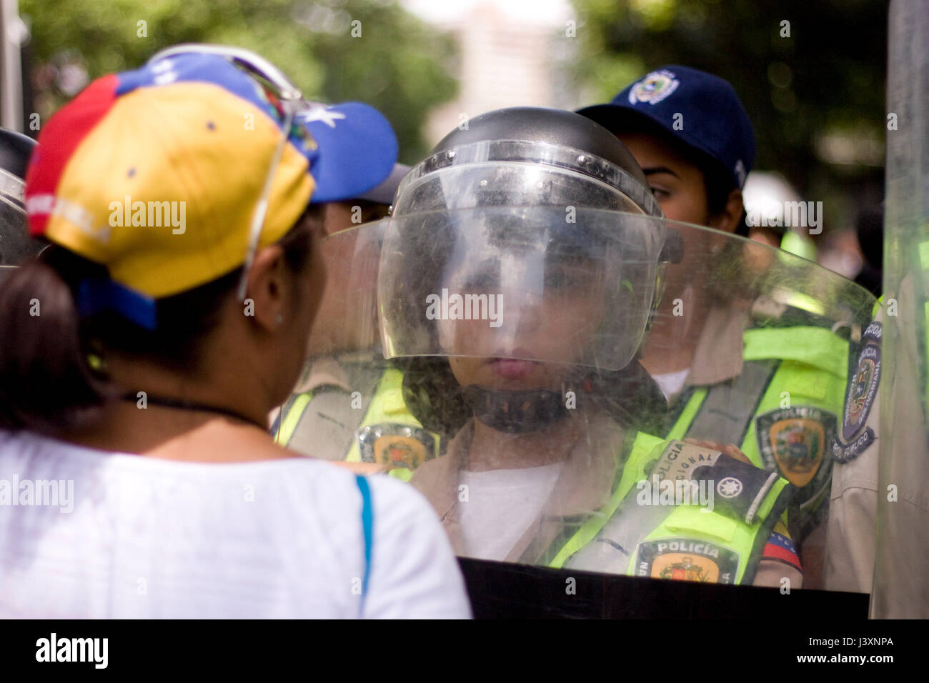 A woman talks with a female police officer during a protest in Caracas ...