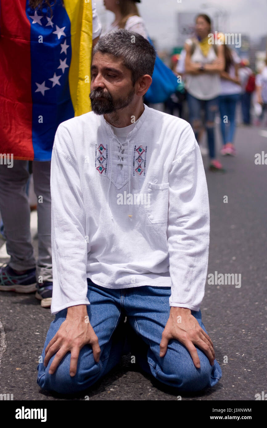 A Man On His Knees And Crying During A Protest Against The Government Of Nicolas Maduro Stock