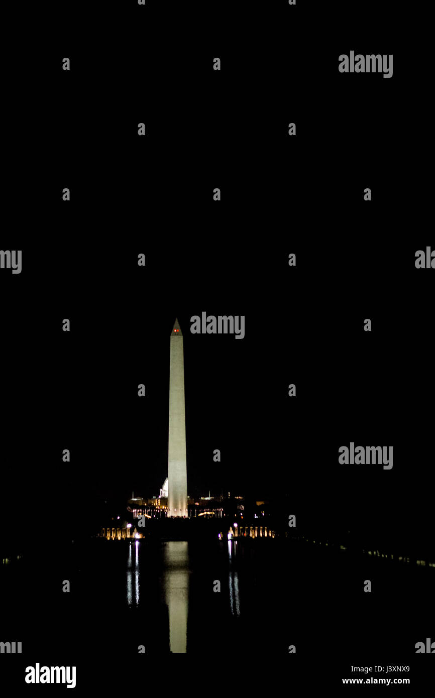 Washington Monument at night with mirror reflection on water ...