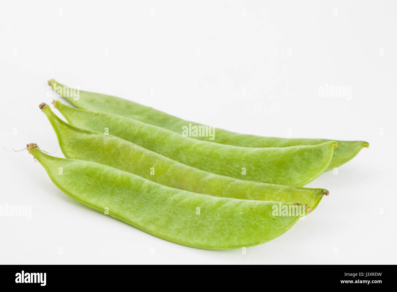 Green peas (Pisum sativum) isolated in white background Stock Photo - Alamy