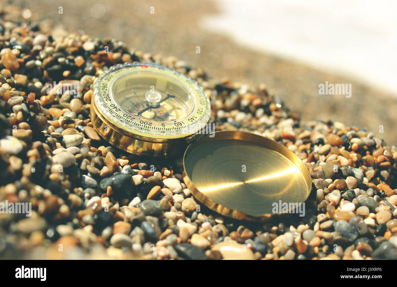 Compass on the beach Stock Photo - Alamy
