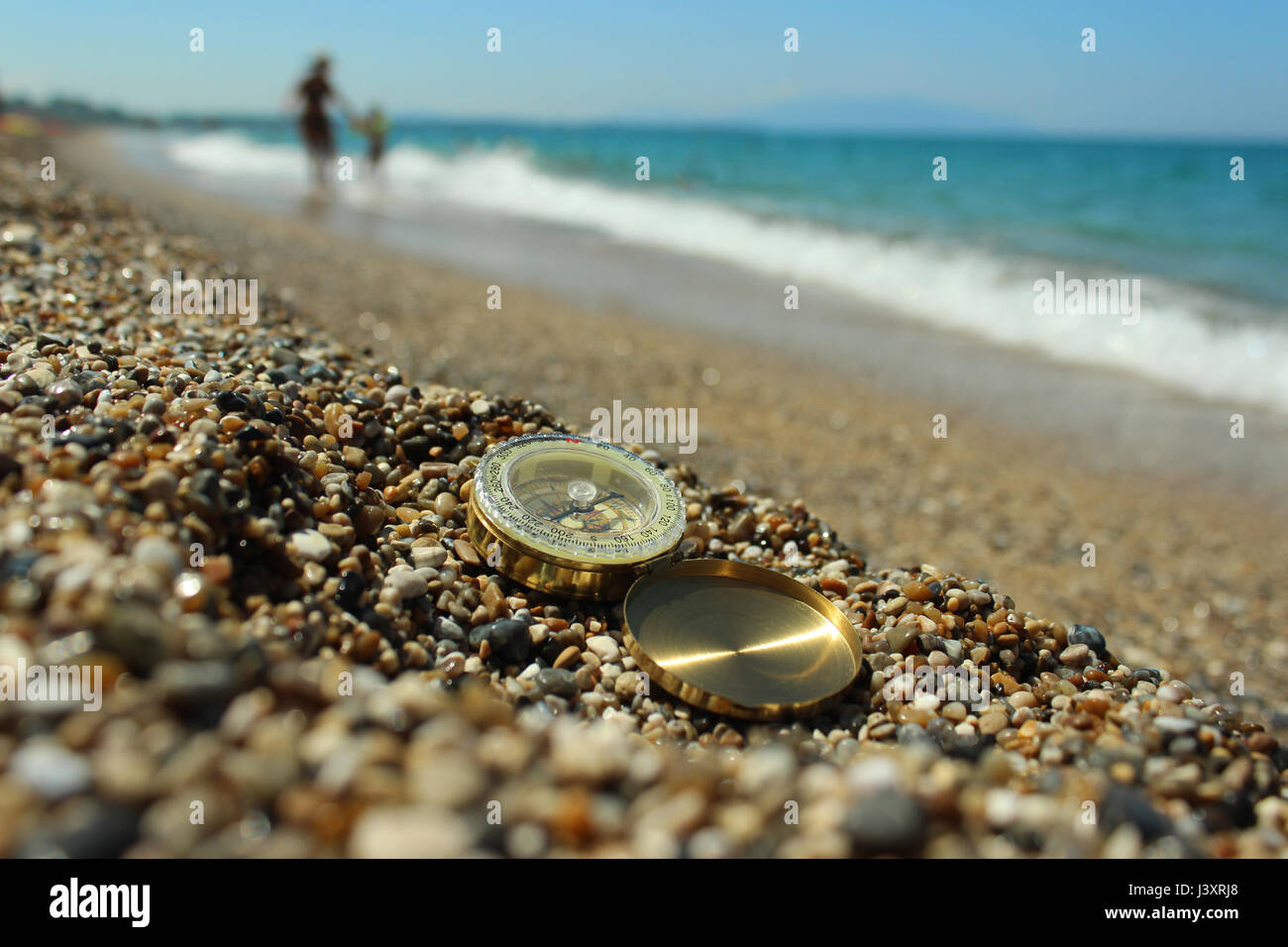 Compass on the beach Stock Photo - Alamy
