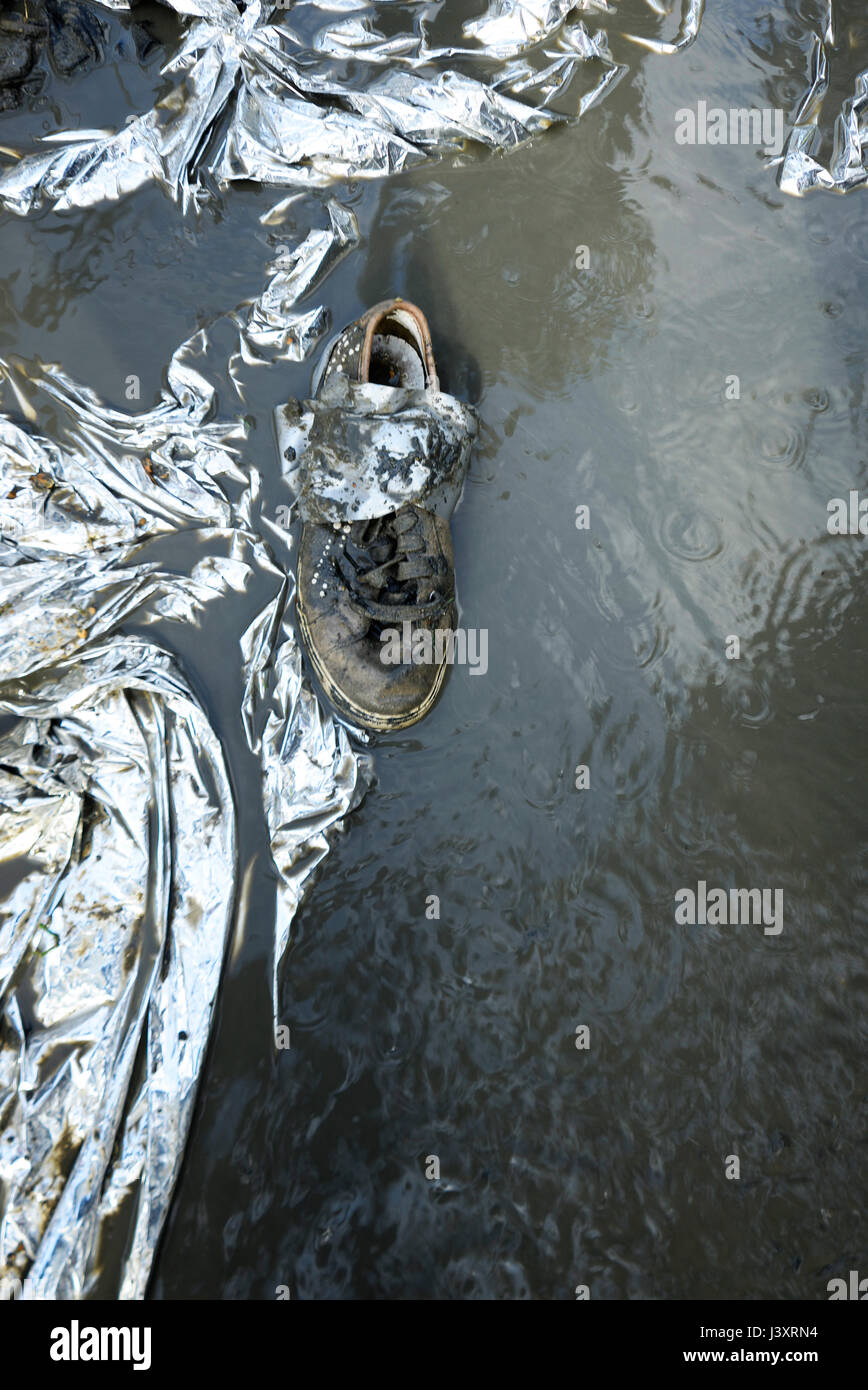 Discarded shoe at the Mad Maldon Mud Race covered in mud from racing ...