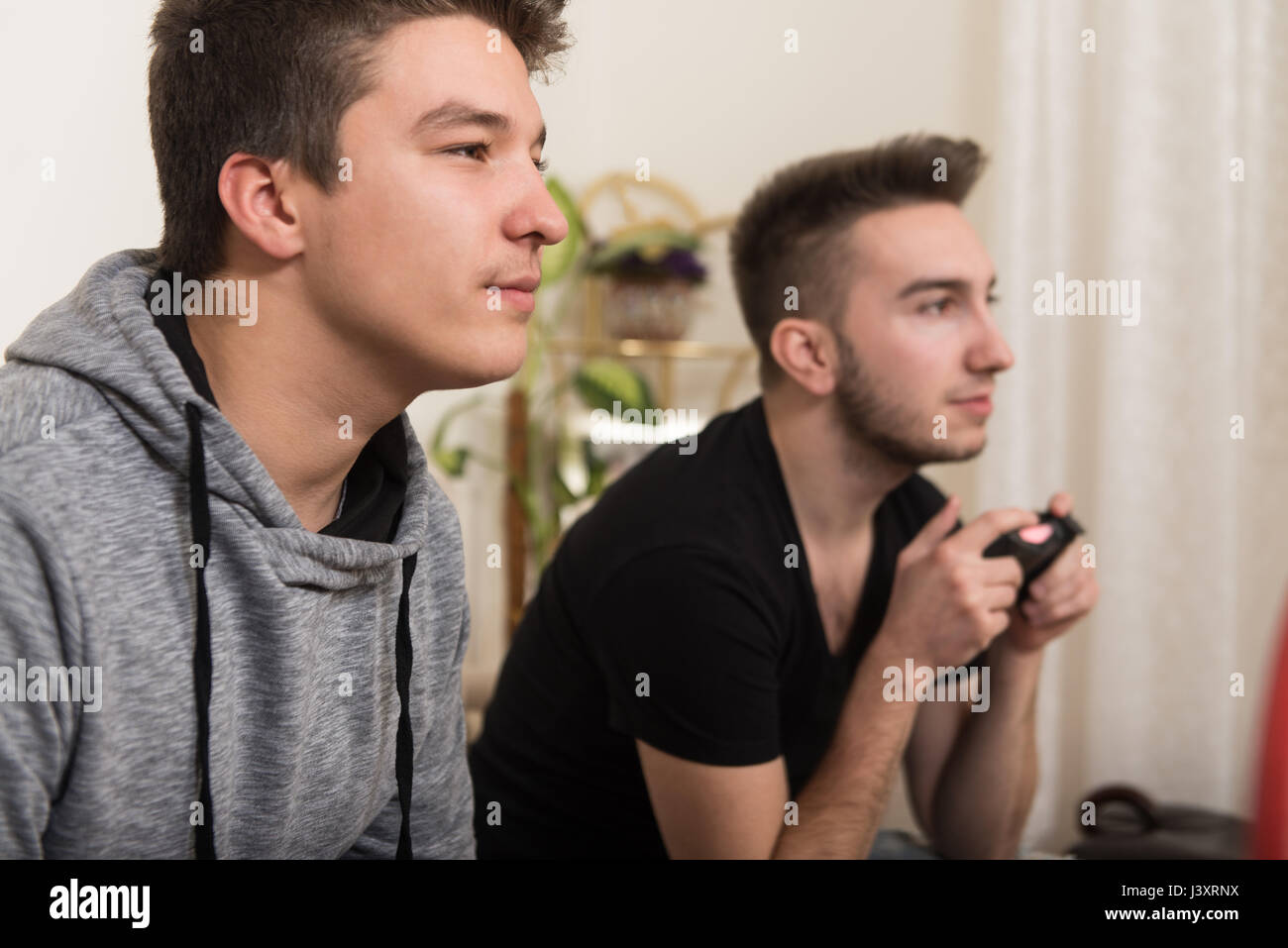Two boys playing a video game hi-res stock photography and images - Alamy