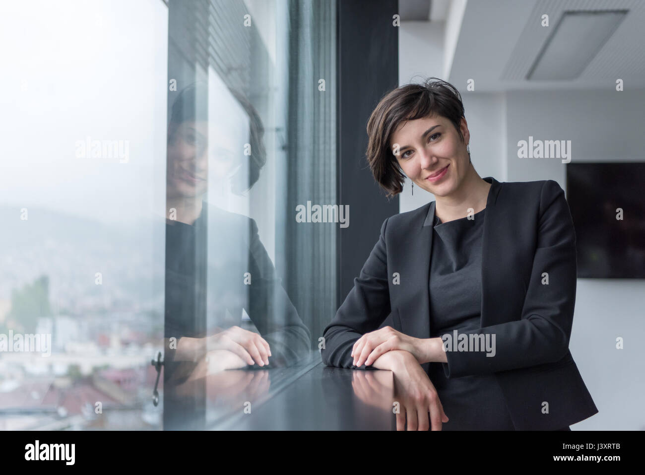 Portrait Of Successful Businesswoman by the window Entrepreneur At Busy ...