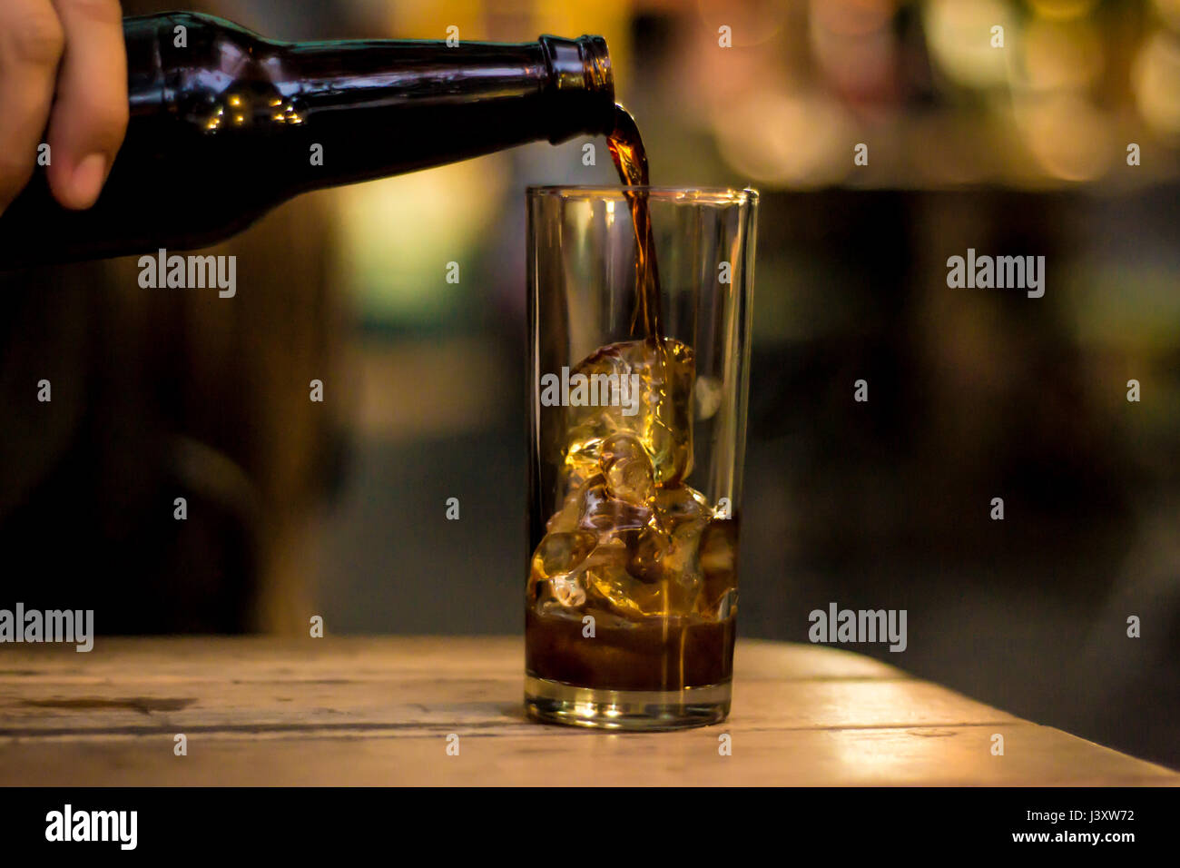 Close up of a hand serving a drink in a bar Stock Photo - Alamy