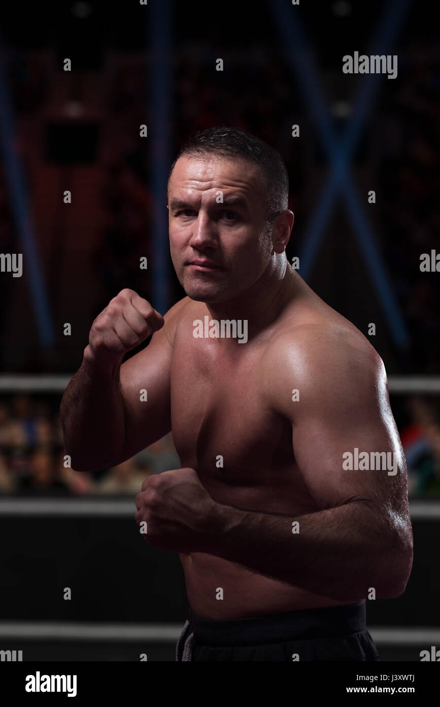 professional kickboxer with hands in martial arts position training for ...