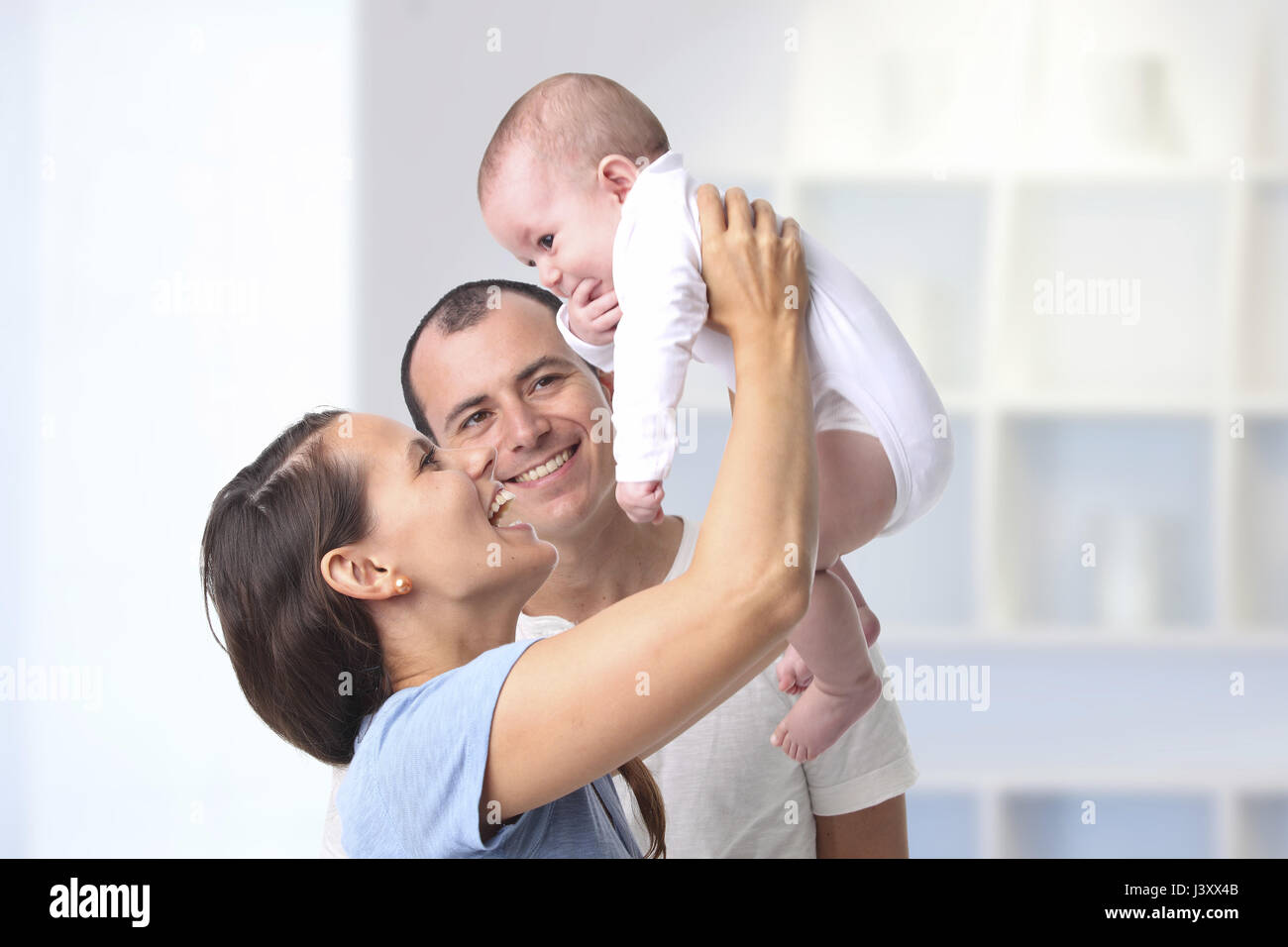 Happy parents lifting child hi-res stock photography and images - Alamy