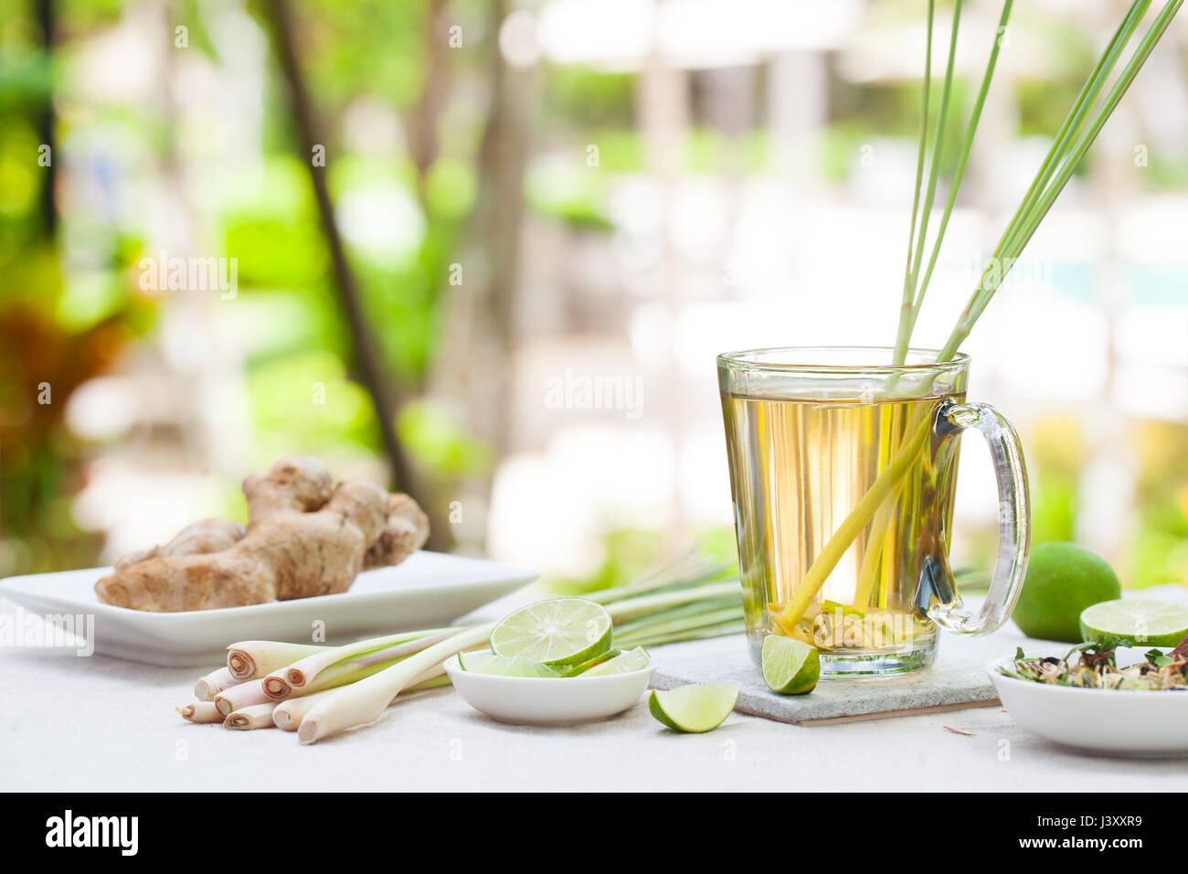 Herbal green tea with lemongrass and ginger in glass cup with fresh ...