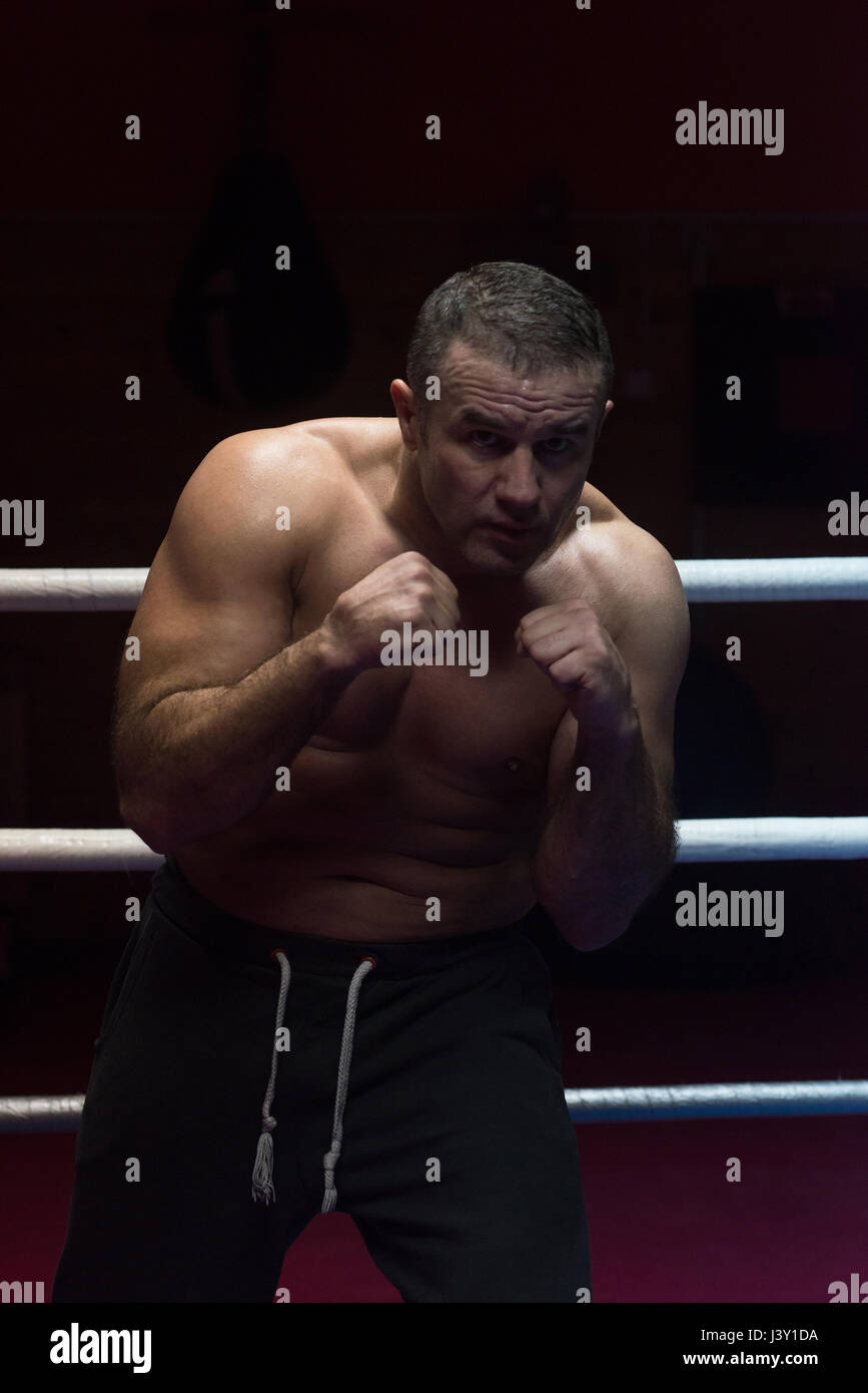 professional kickboxer with hands in martial arts position training for ...