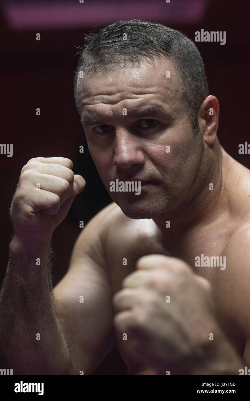 professional kickboxer with hands in martial arts position training for ...