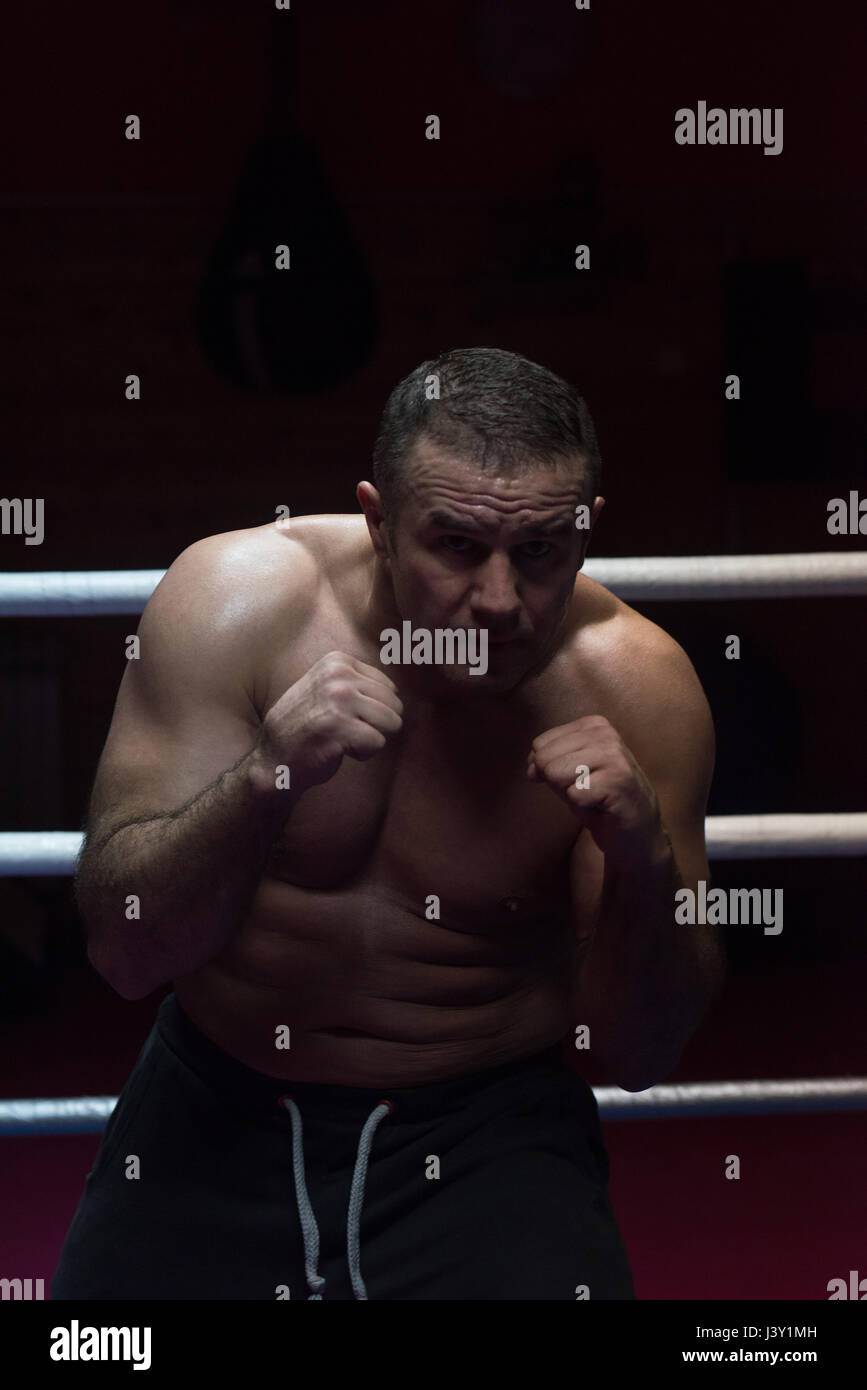 professional kickboxer with hands in martial arts position training for ...