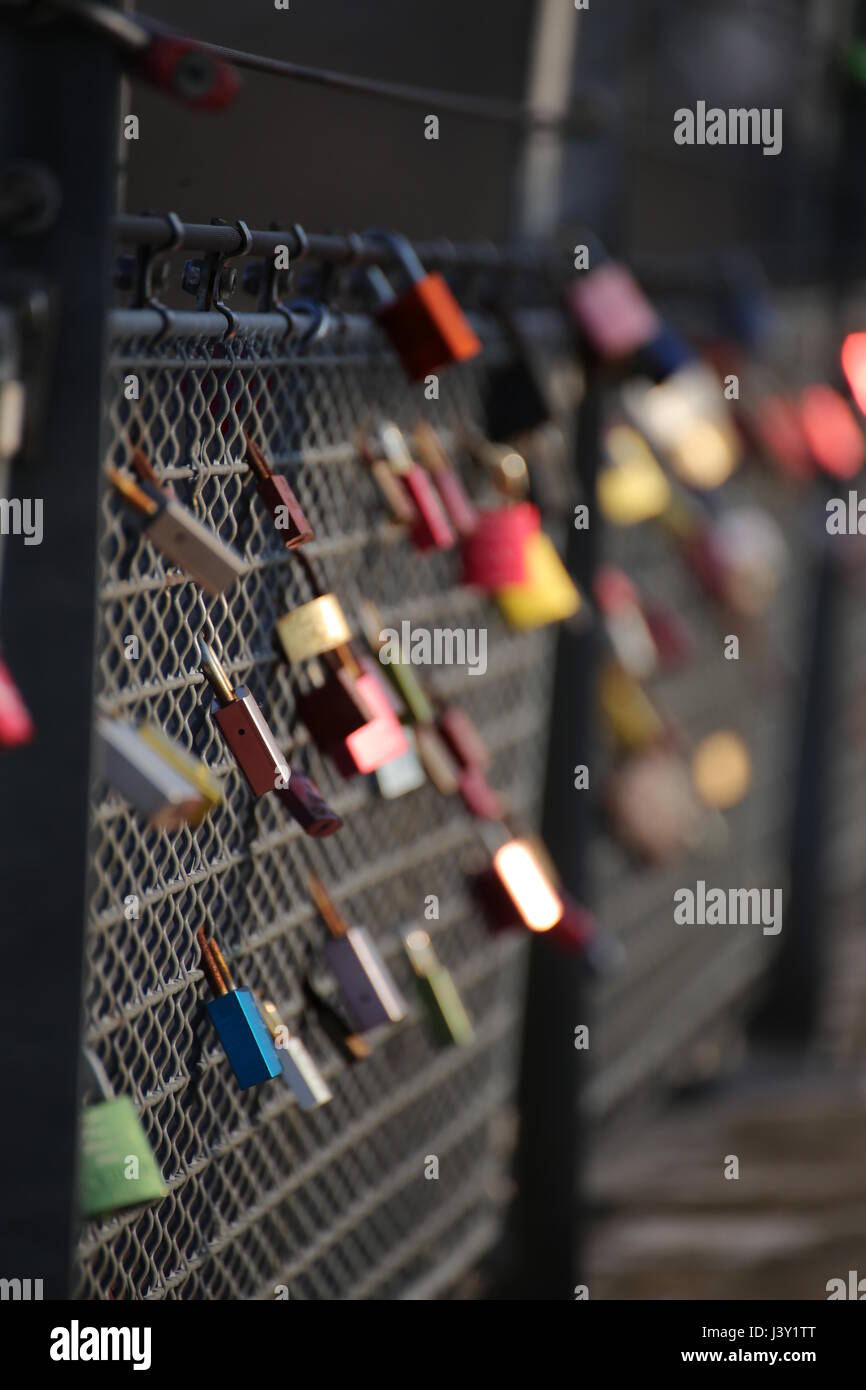 Love locks hanging on a bridge railing Stock Photo - Alamy