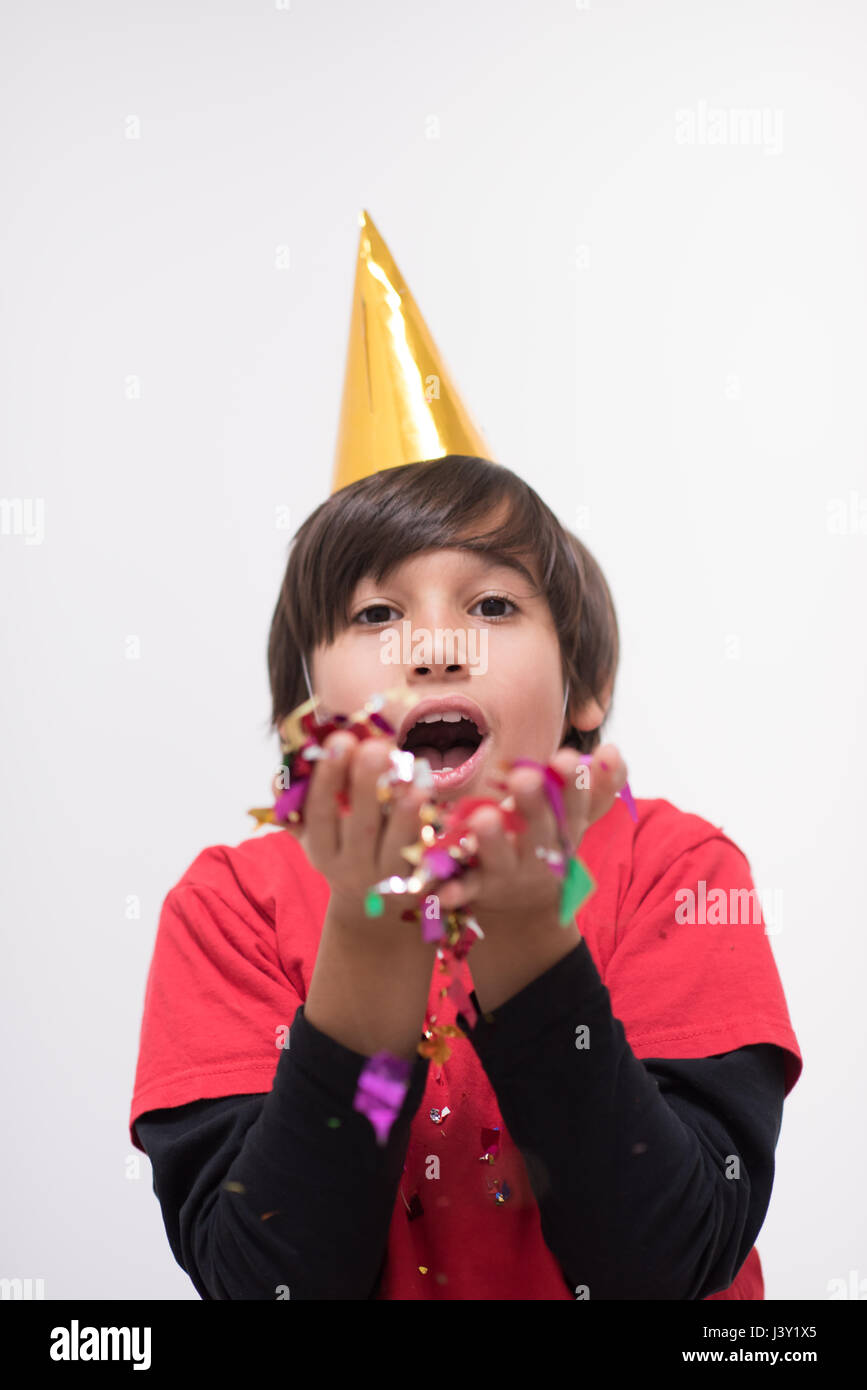 Happy kid celebrating party with blowing confetti Stock Photo - Alamy