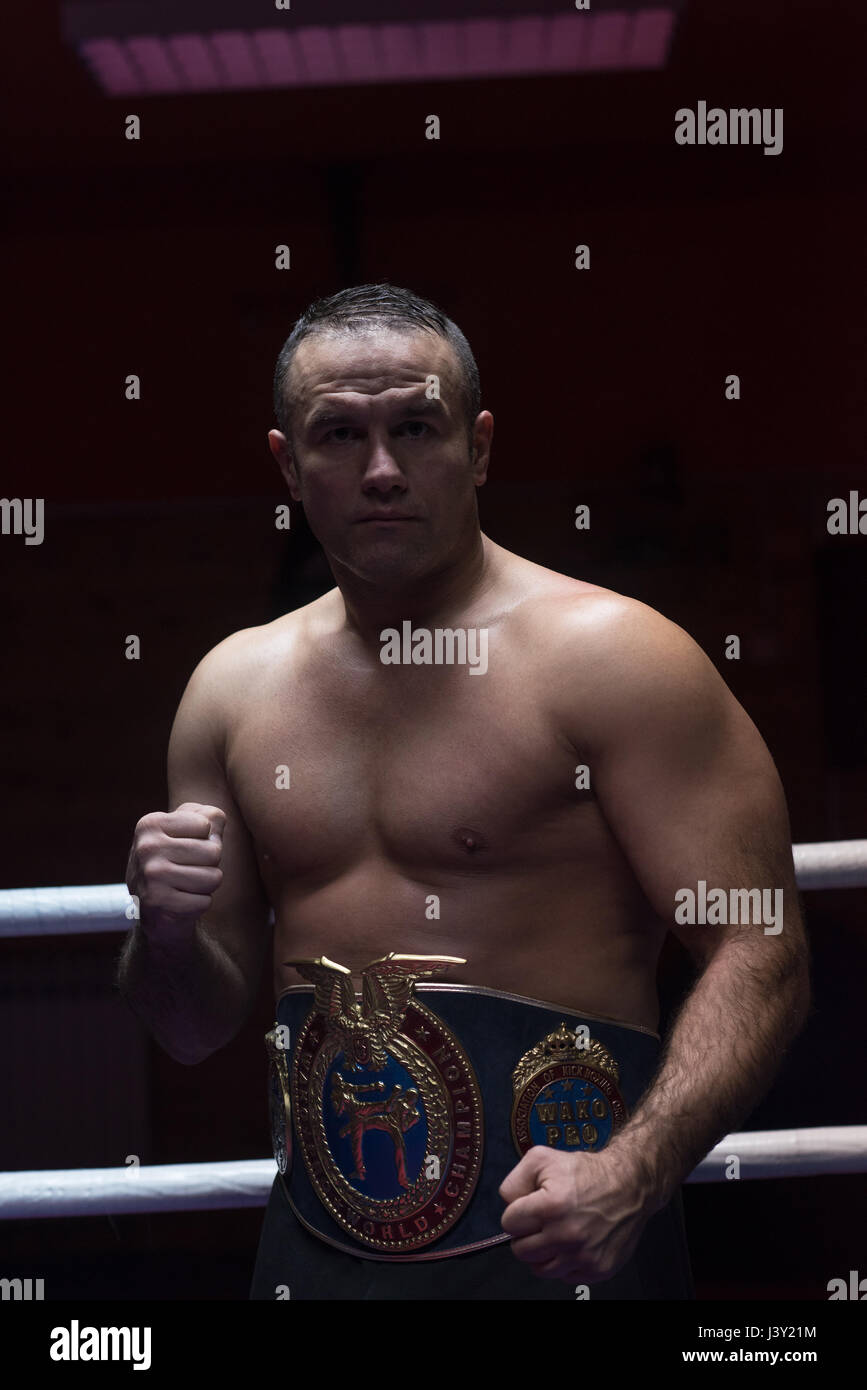 portrait of muscular professional kick boxer with his championship belt ...