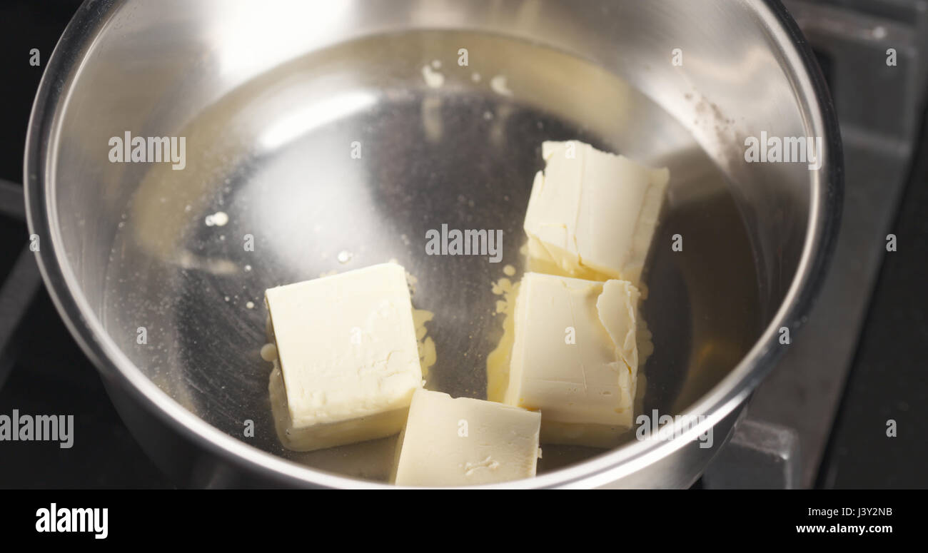 Handheld shot of adding butter into water Stock Photo - Alamy