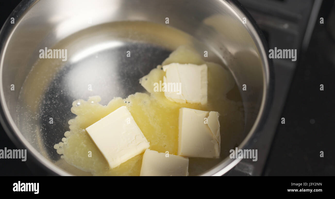 Handheld shot of butter melting in water Stock Photo - Alamy