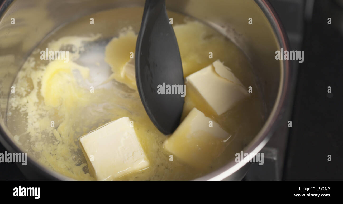 Handheld shot of butter melting in water Stock Photo - Alamy