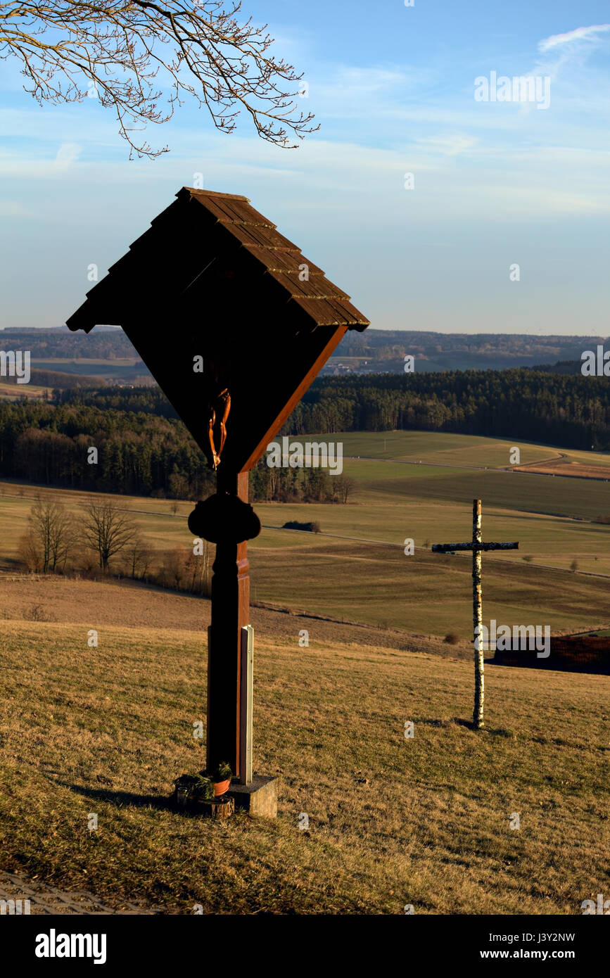 Wayside cross with carvings in shadow and a simple Birch cross Stock ...