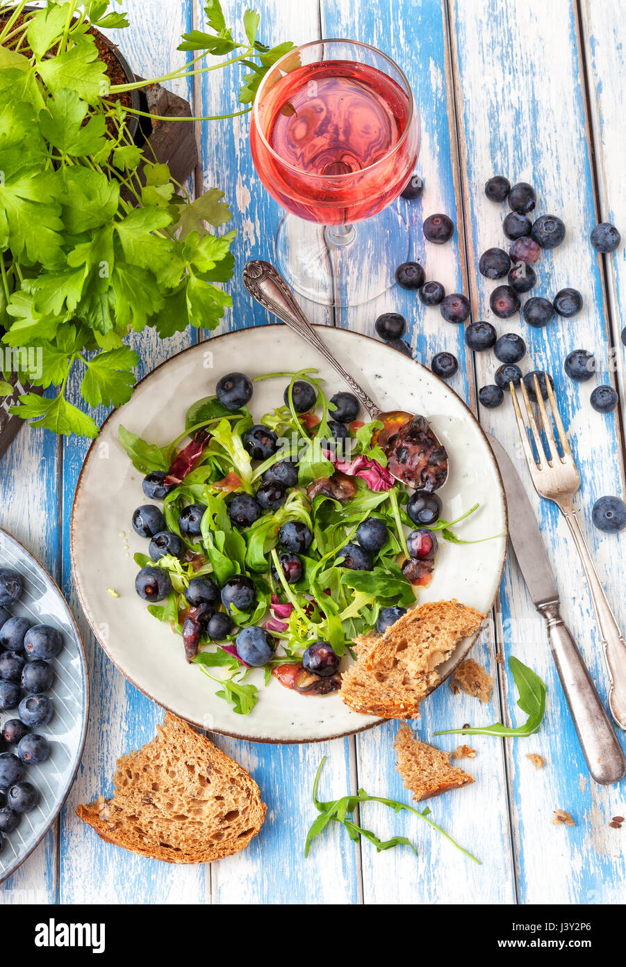 Healthy salad with rocket and blueberries on an outdoor table Stock ...