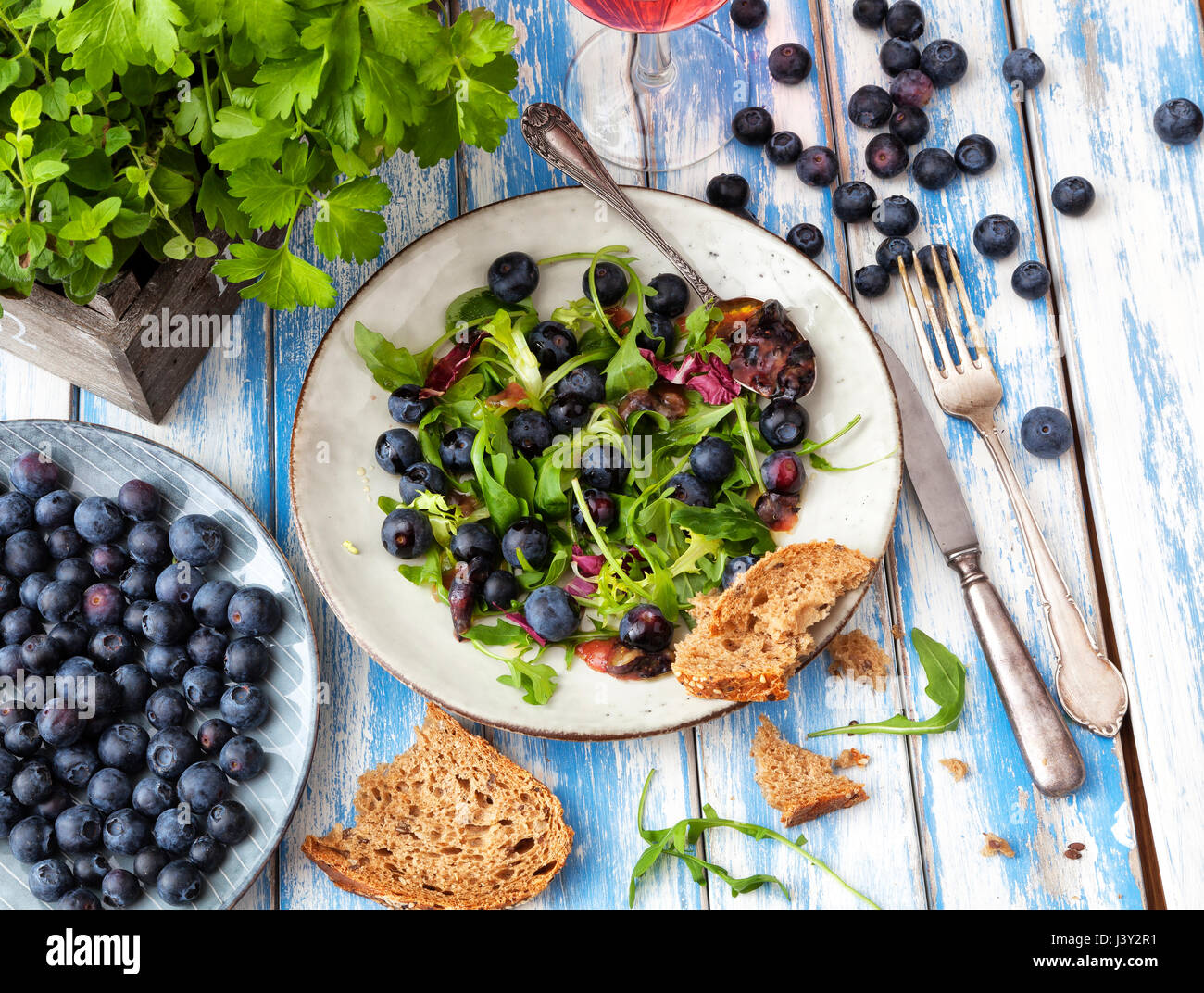 Healthy salad with rocket and blueberries on an outdoor table Stock ...