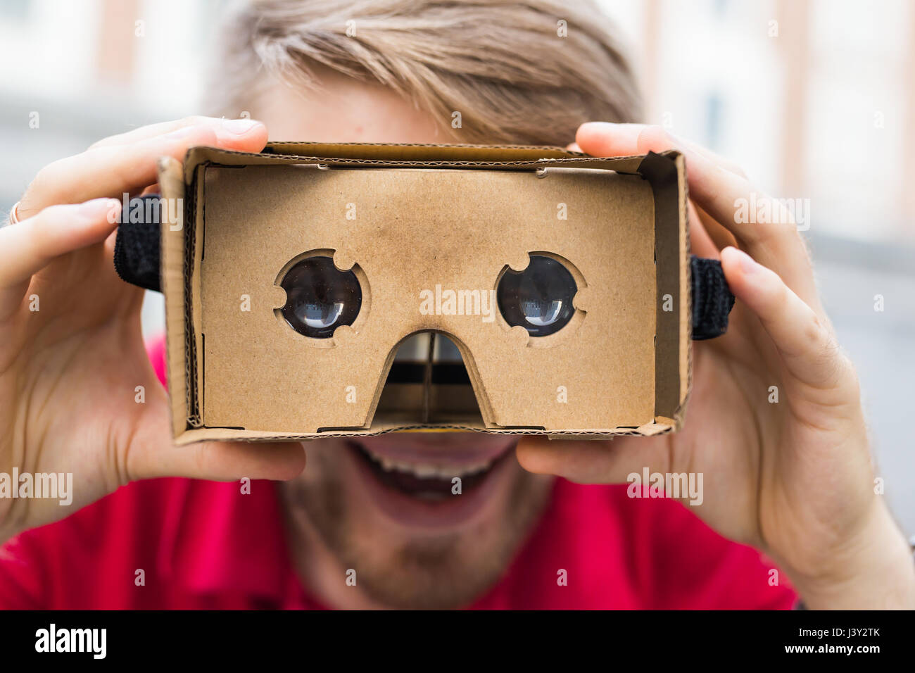 Funny man using cardboard virtual reality goggle outdoors Stock Photo ...