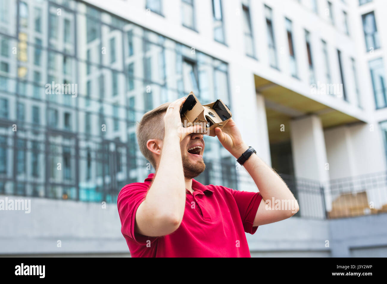 Funny man using cardboard virtual reality goggle outdoors Stock Photo ...
