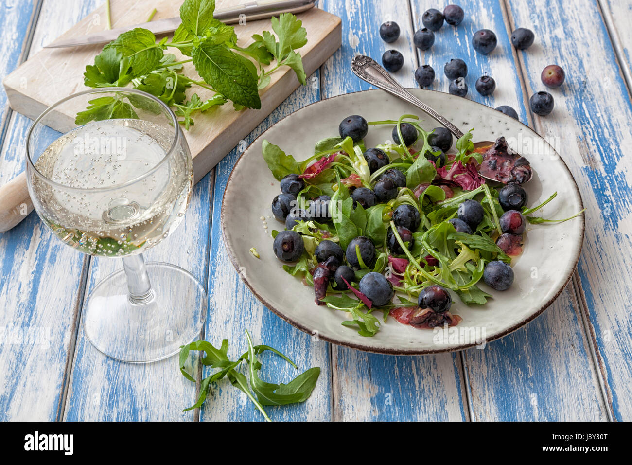 Healthy salad with rocket and blueberries on an outdoor table Stock ...