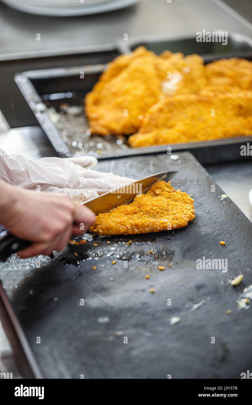 Chef cut breaded german weiner schnitzel Stock Photo - Alamy