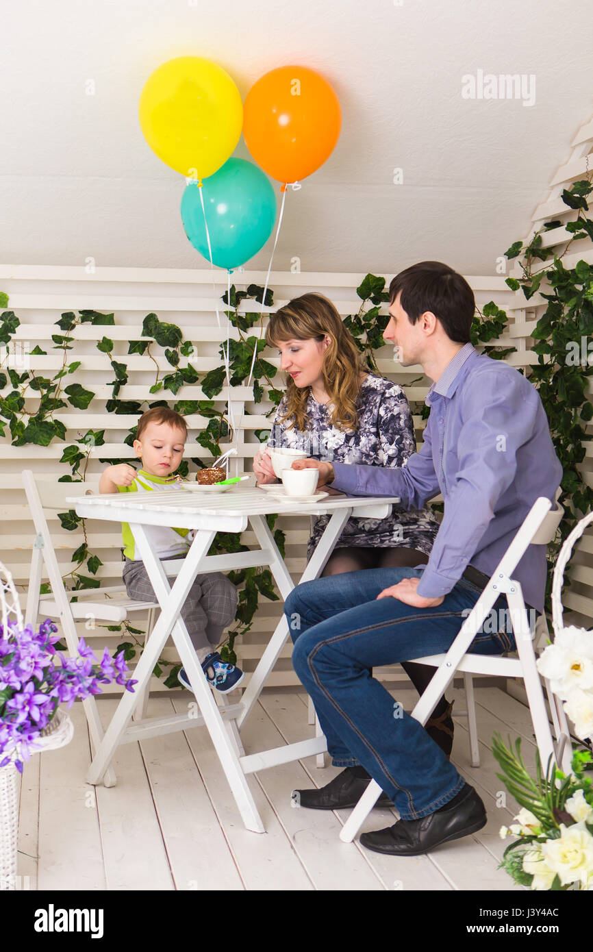 family, parenthood, happy birthday and holiday concept - happy parents ...