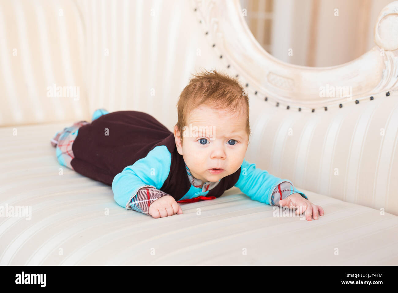 Portrait of adorable baby boy lying on tummy Stock Photo - Alamy
