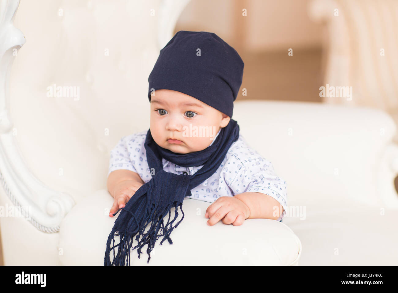 Portrait of cute baby boy wearing blue hat Stock Photo - Alamy