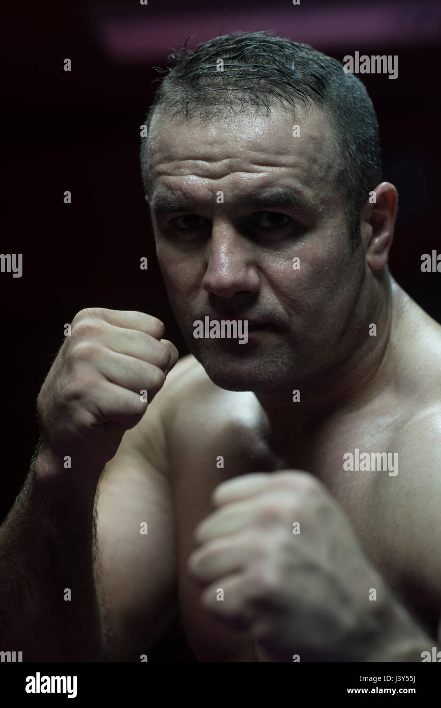 professional kickboxer with hands in martial arts position training for ...