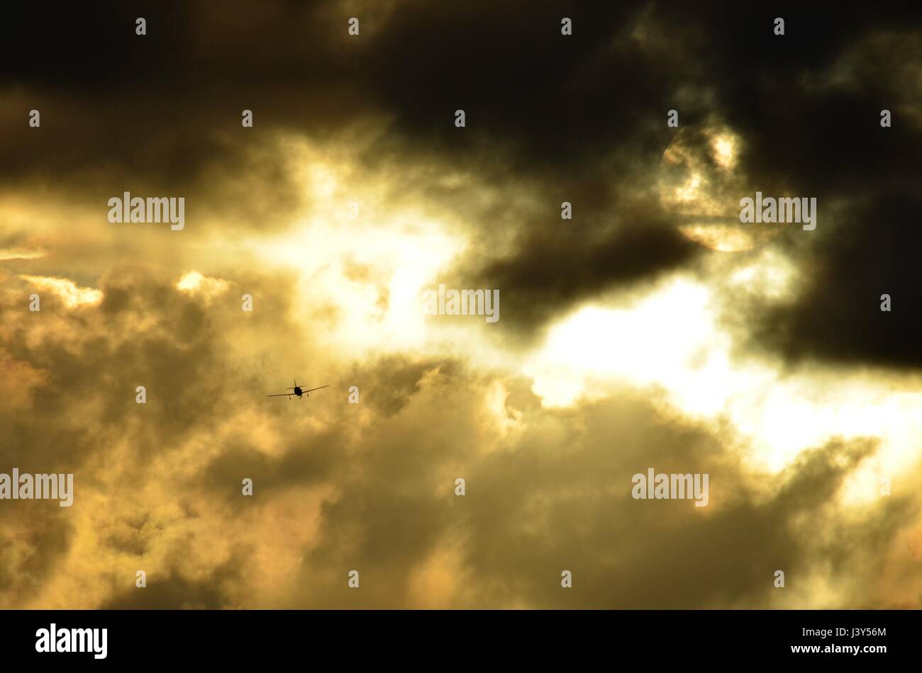 Flying in stormy sky. Small plane in flight between clouds of storm ...