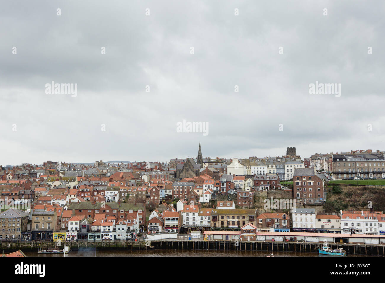 view of whitby from across the bay, showing the houses, and harbour ...