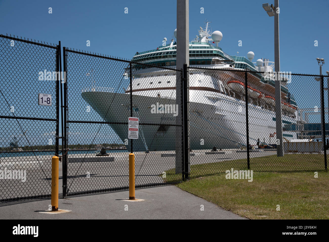Security fence around a cruise ship on the quay at Port Canaveral ...