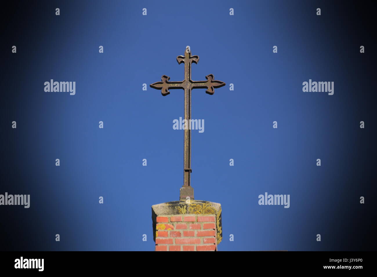 Christian metal cross on top of a clinker church Stock Photo - Alamy