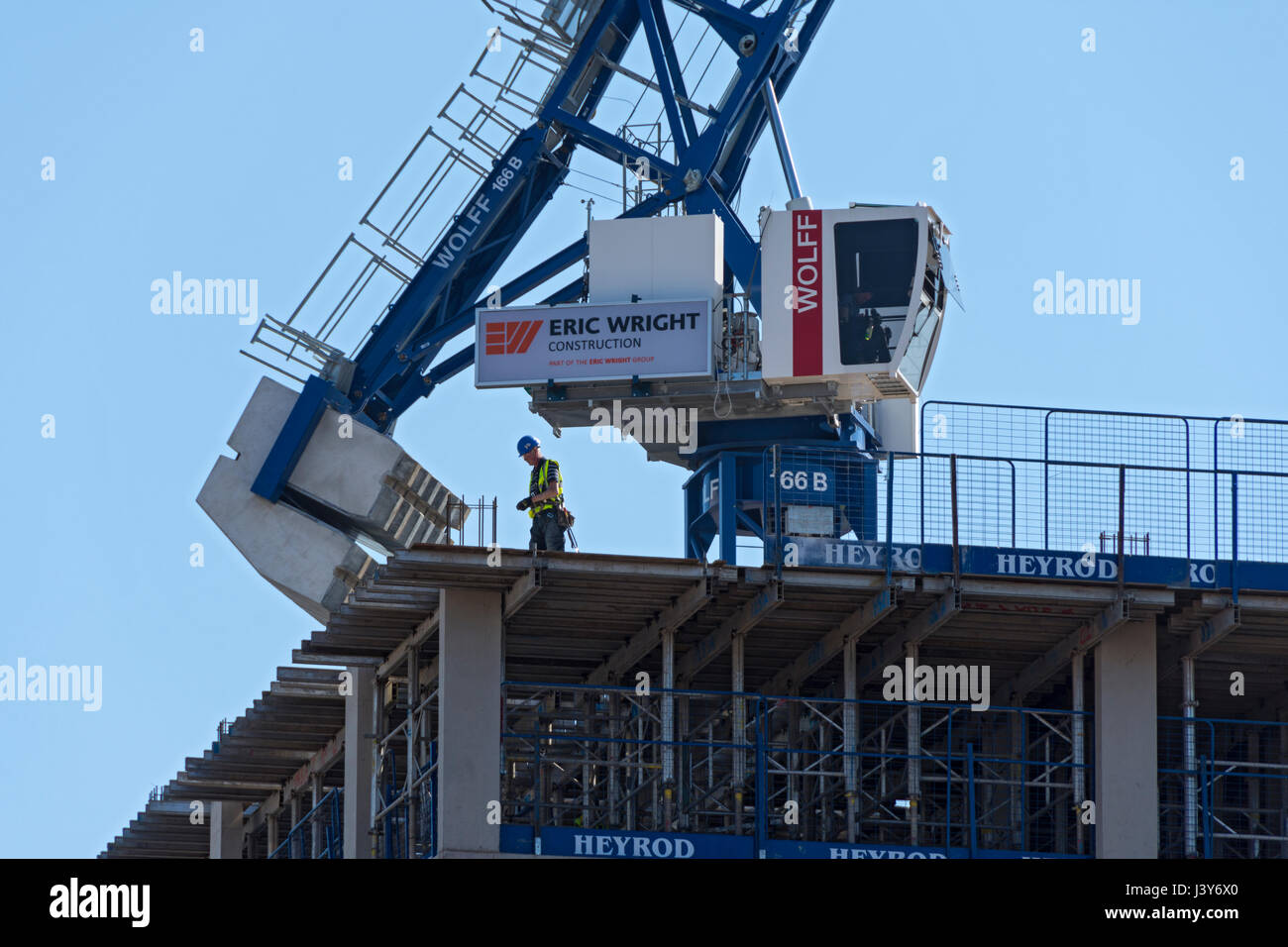 Workman and a tower crane cab on a construction site in Ancoats ...
