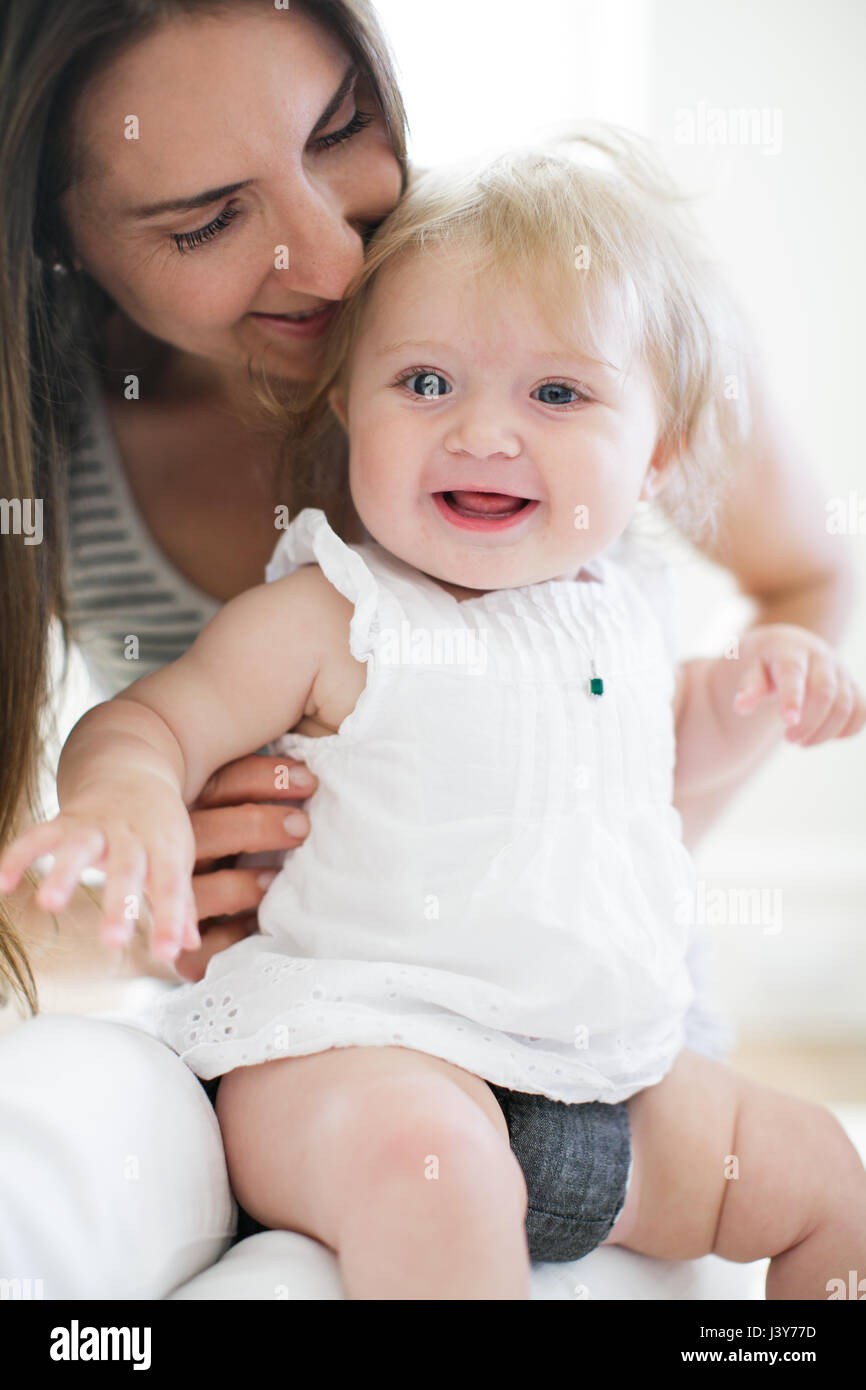 Girl sitting on mothers lap hi-res stock photography and images - Alamy