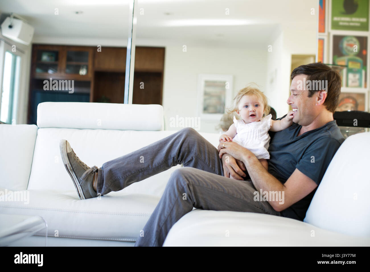 Daughter sitting on fathers lap hi-res stock photography and images - Alamy