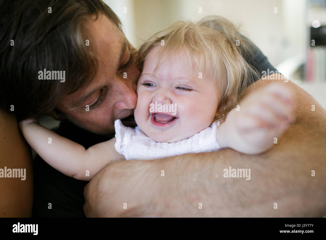 Hugging baby daughter hi-res stock photography and images - Alamy