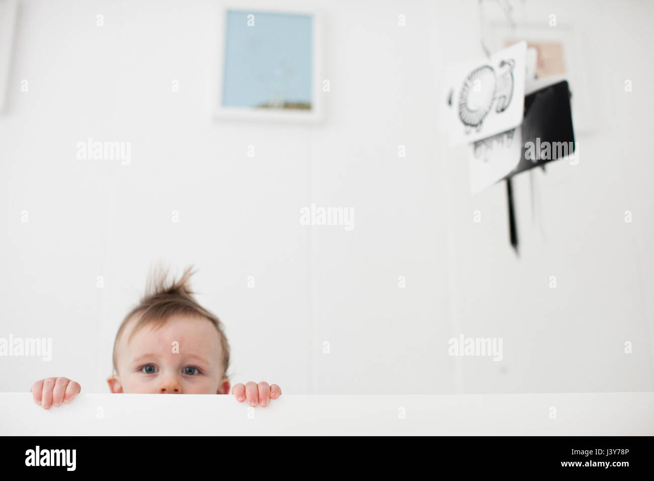 Portrait of baby boy staring from crib Stock Photo - Alamy