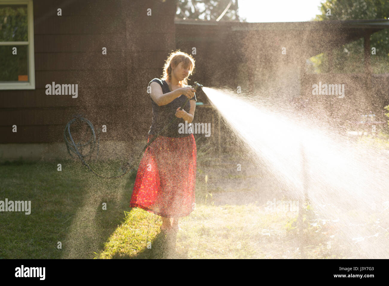 Adult garden hose sun hi-res stock photography and images - Alamy