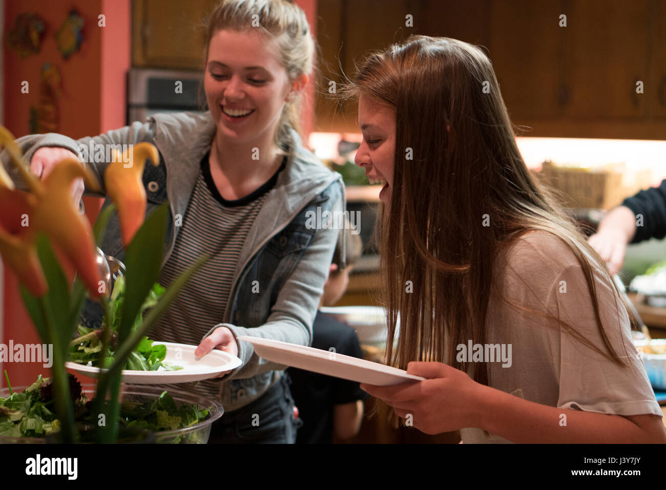 Teenage girls in kitchen preparing meal Stock Photo - Alamy