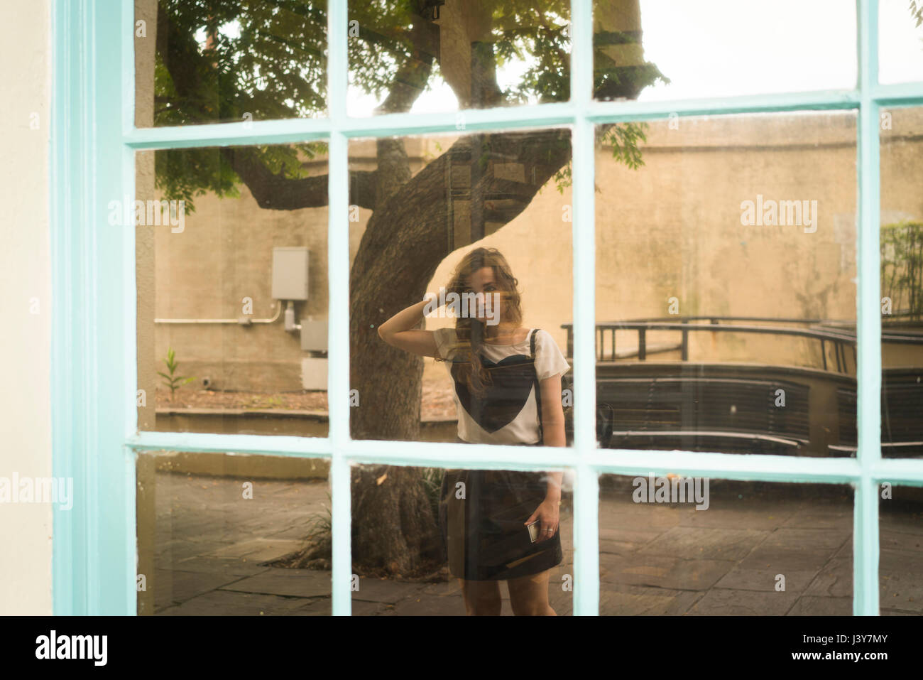 Reflection of woman in shop window Stock Photo - Alamy